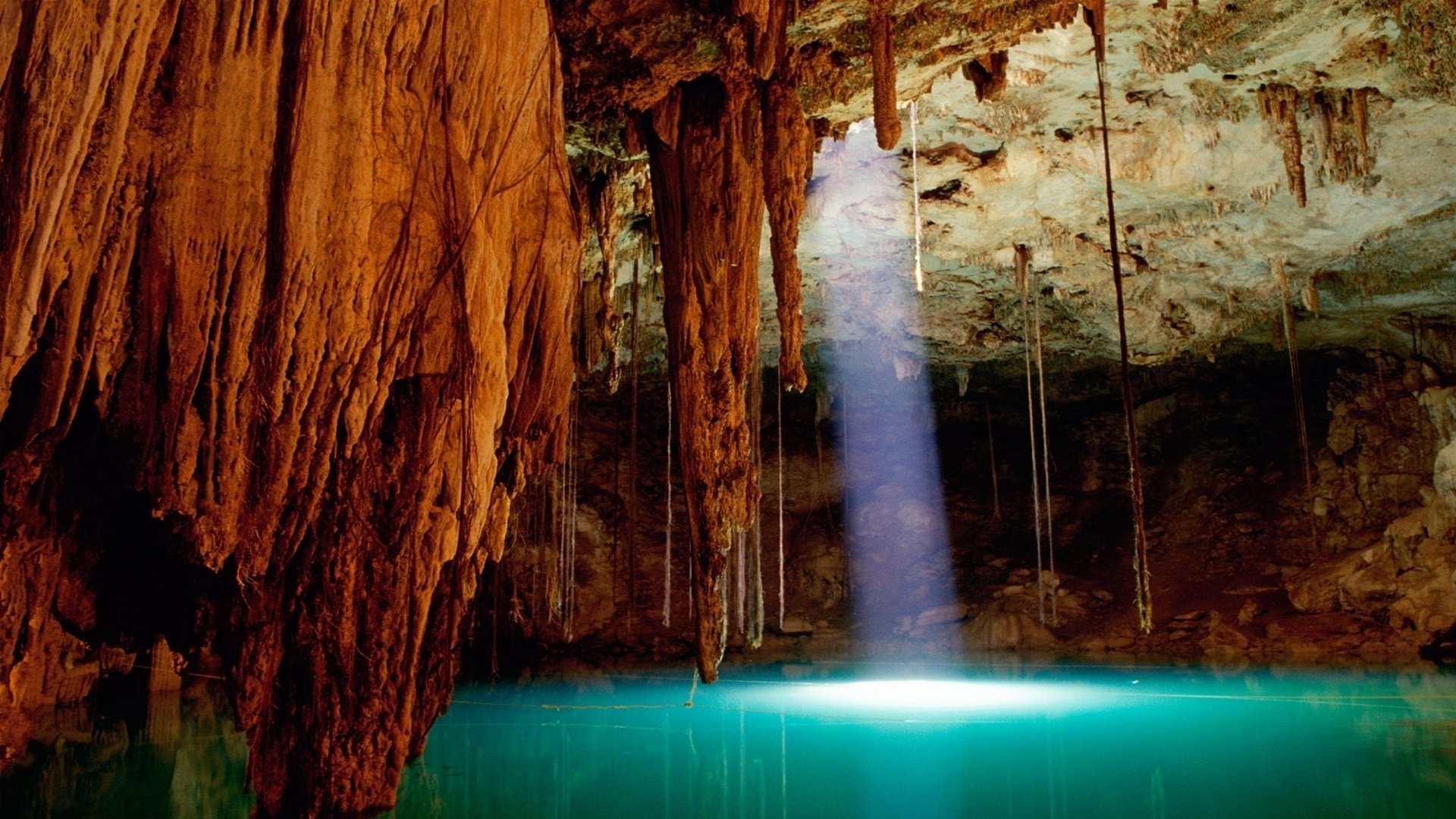 Nature's Glow: Stunning Light Beam in Tranquil Cave HD Wallpaper