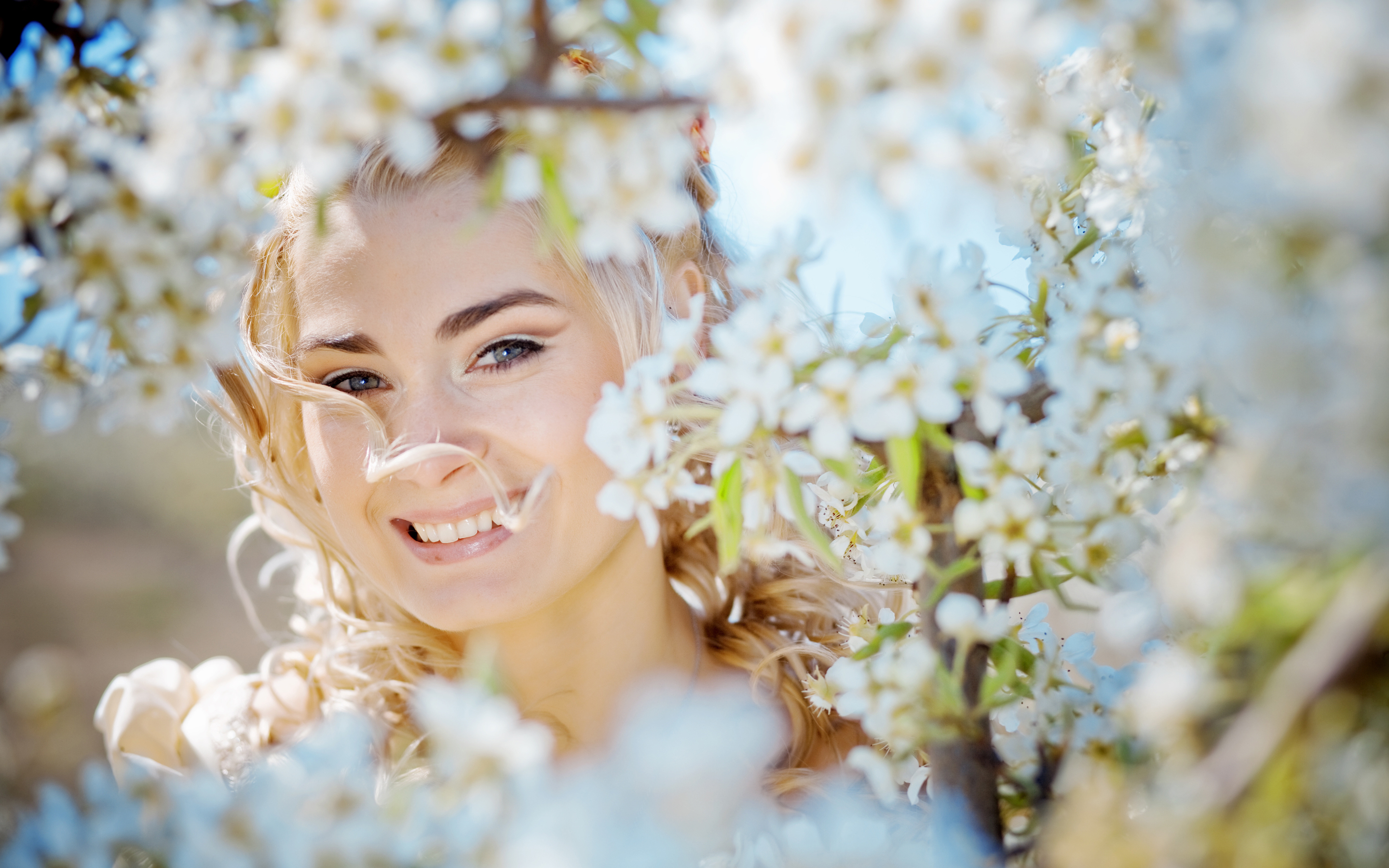 Radiant Spring Glow: Woman's Face in Bloom - HD Wallpaper