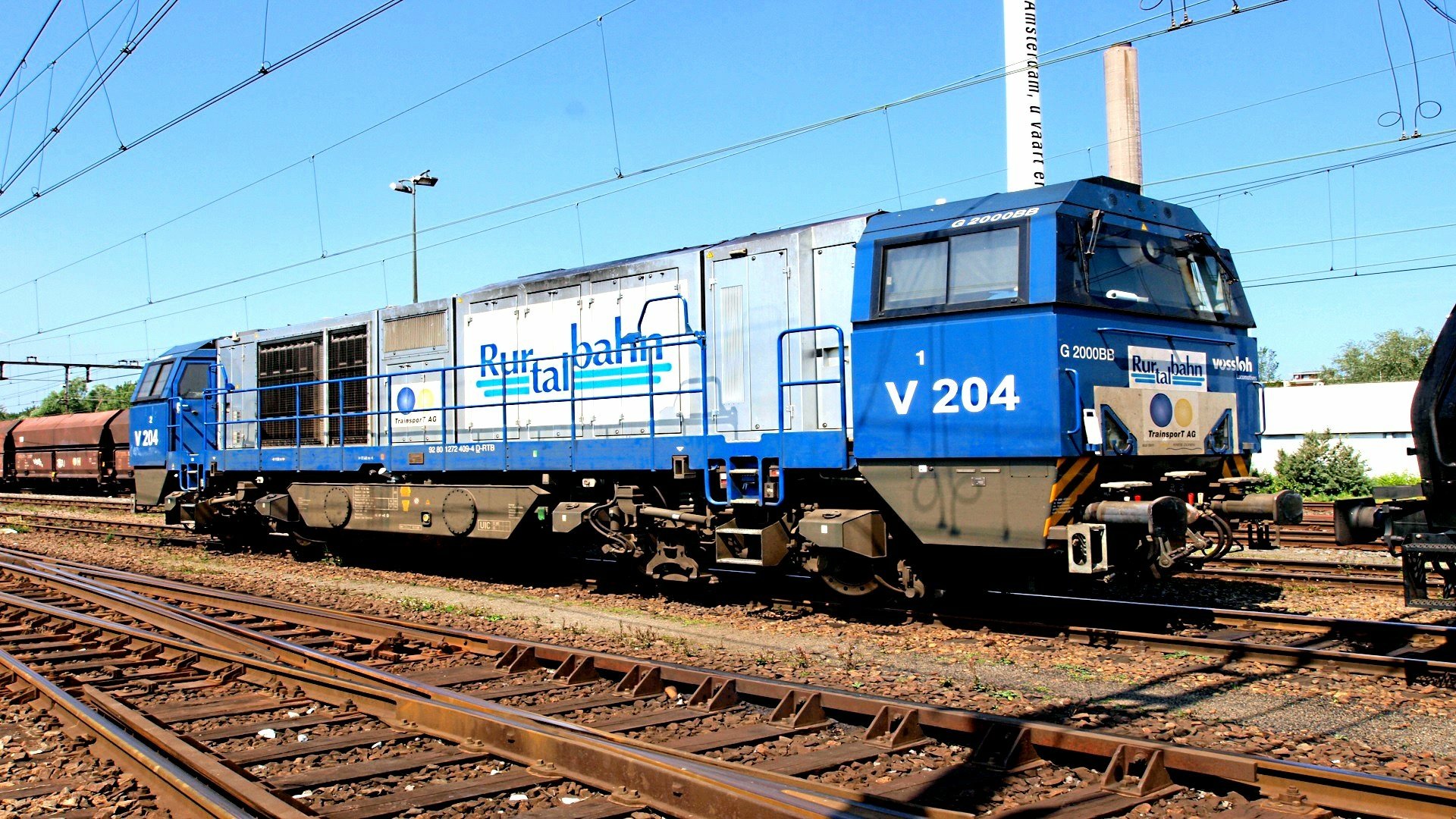 HD Train Power: Vibrant Blue Locomotive on Tracks