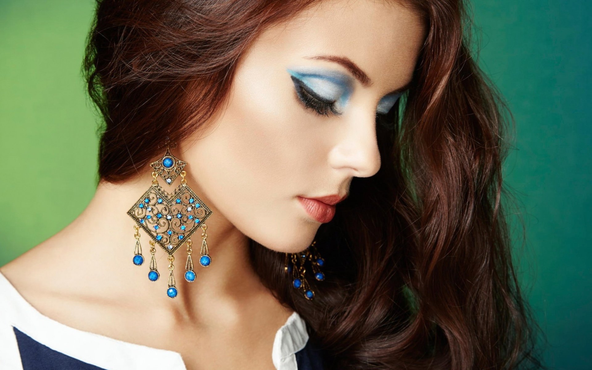 Elegant Brunette Profile with Stunning Makeup and Statement Earrings ...