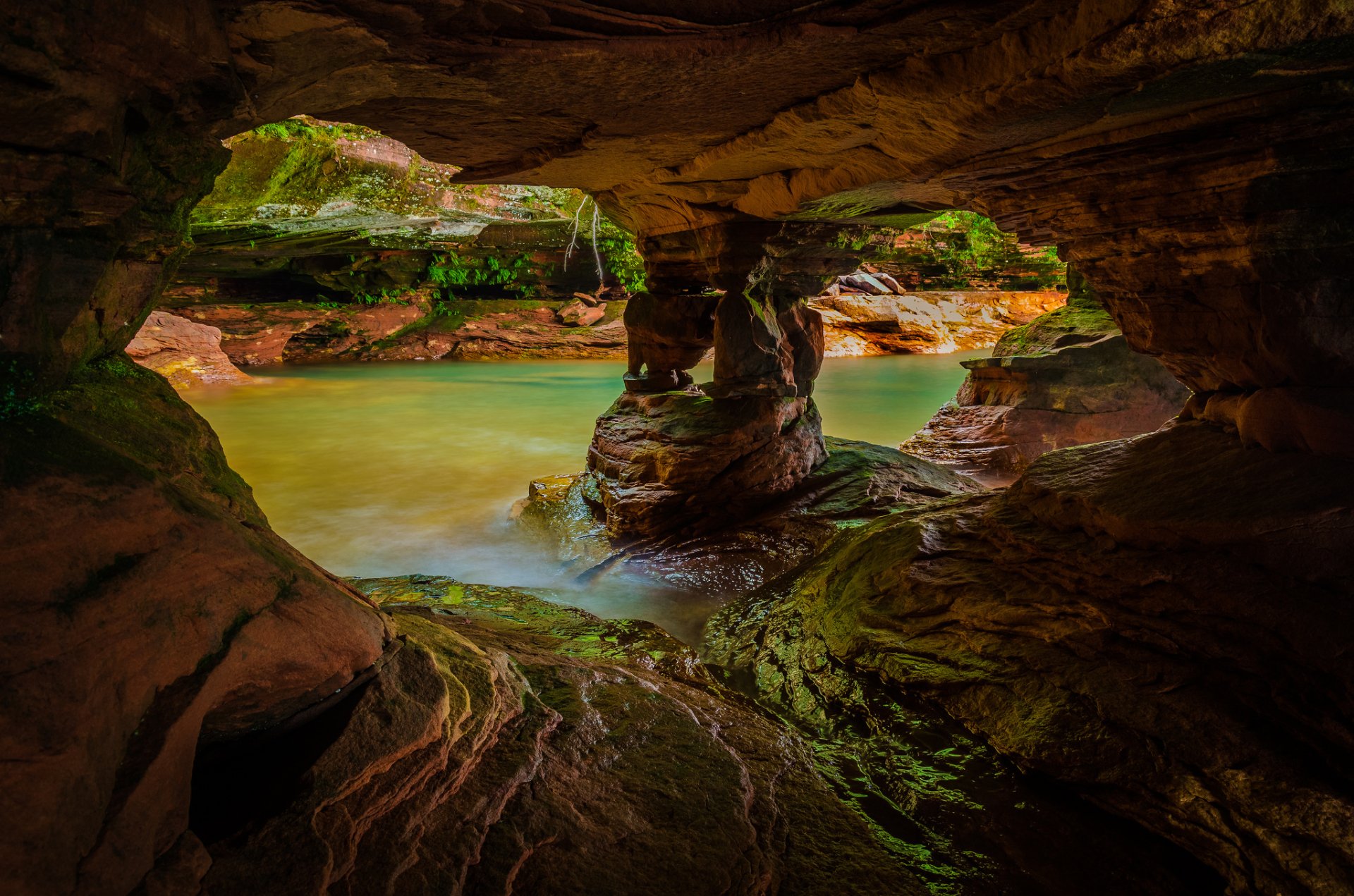 Hidden River View: Nature’s Cave Sanctuary HD Wallpaper