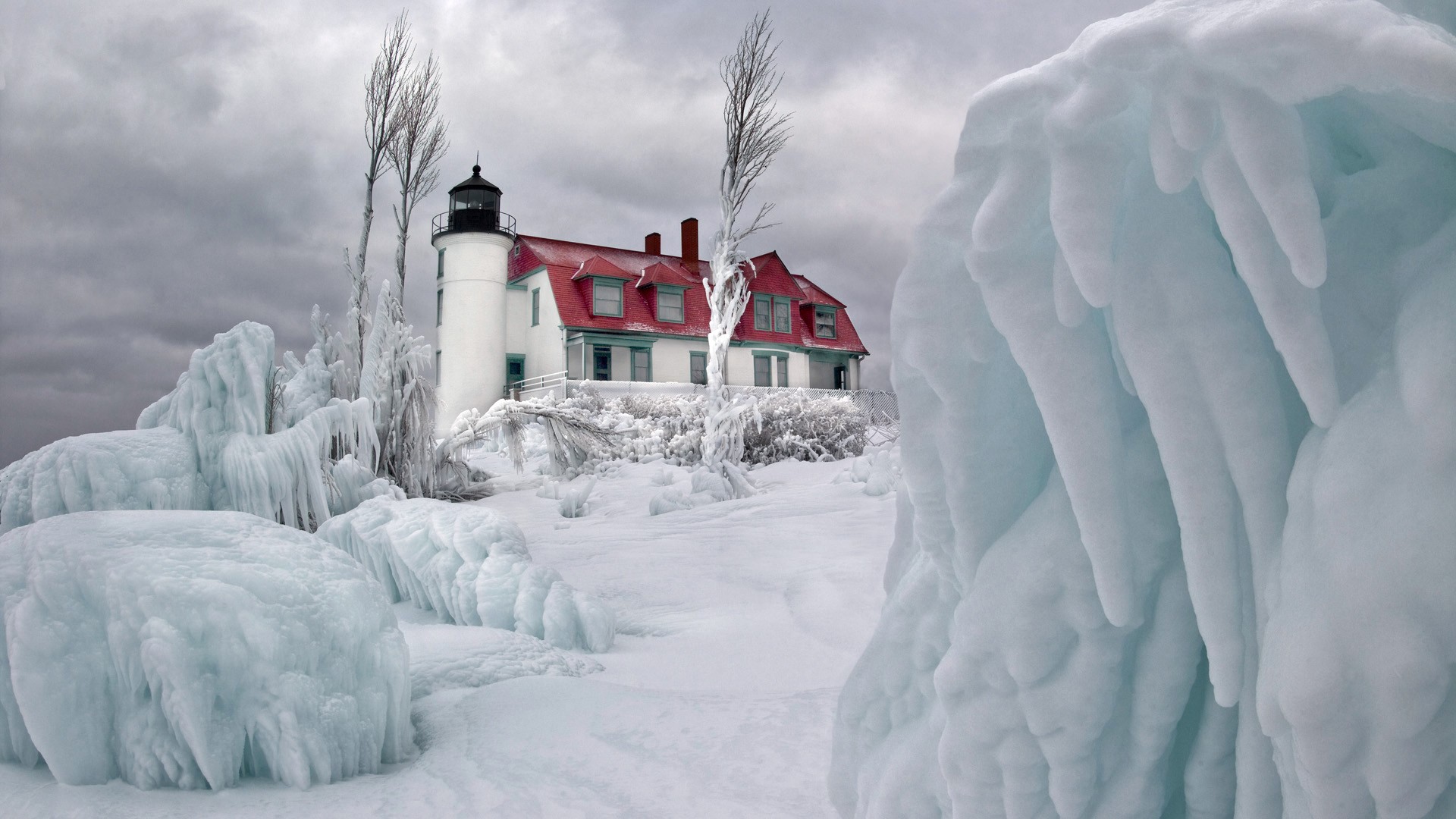 Winter’s Frozen Lighthouse: A Snowy Tree and Ice Wonderland HD Wallpaper