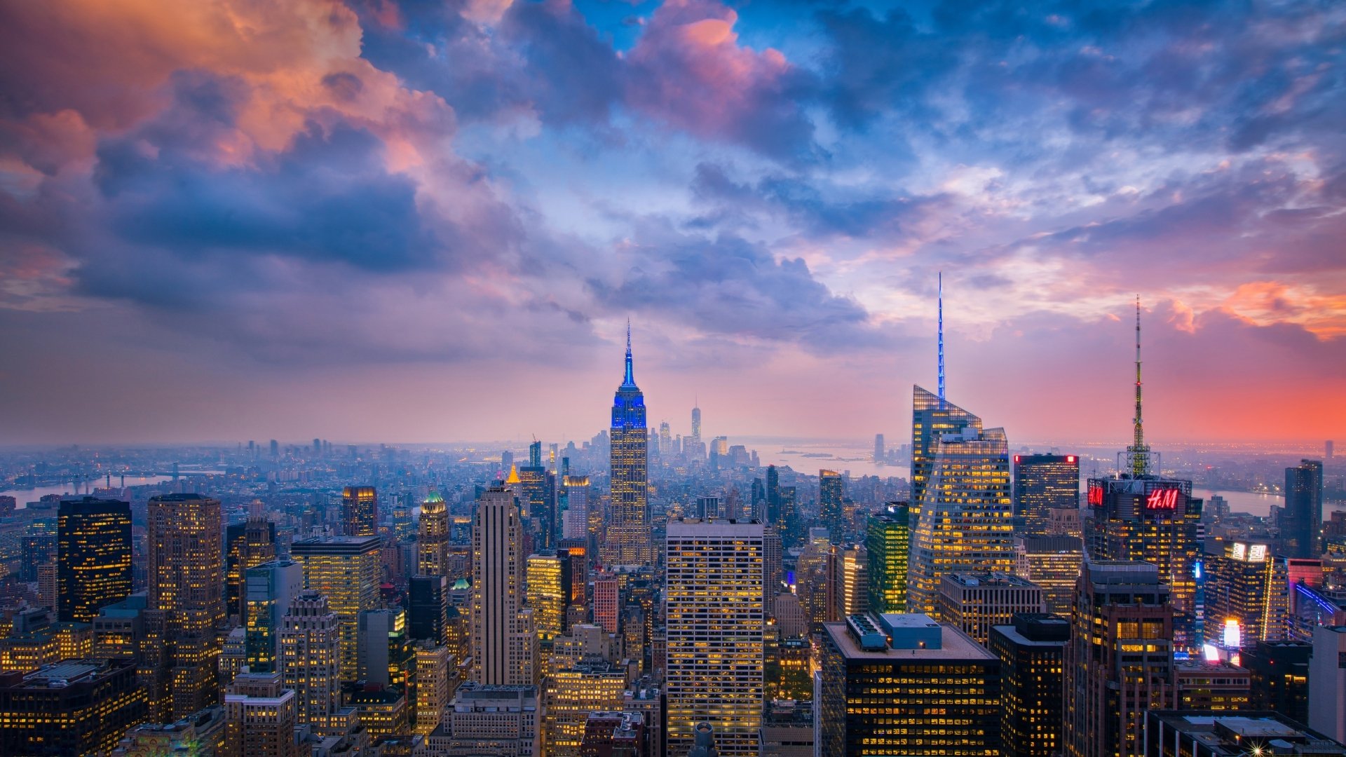 New York Skyline At Dusk Vibrant Cityscape Under Dramatic Clouds Hd